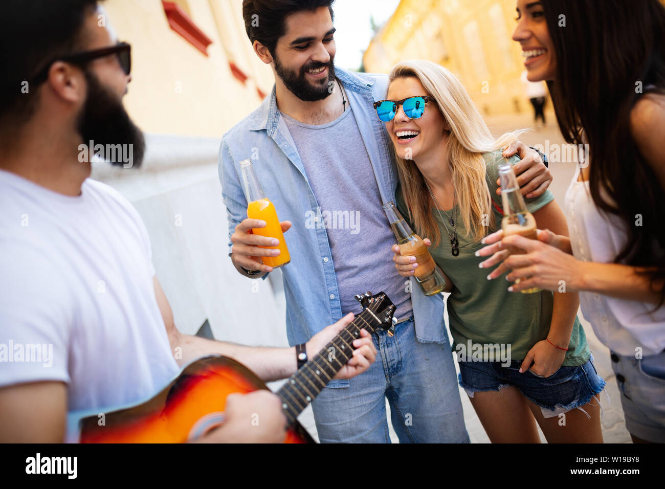 Happy young people having fun spending good time together Stock Photo ...