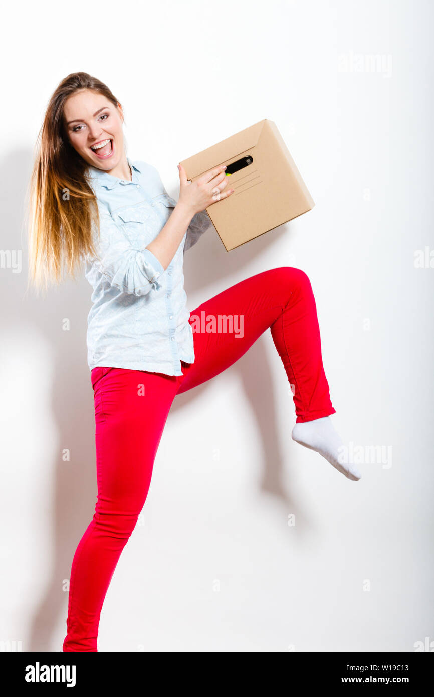 Happy woman moving in carrying carton box. Young girl arranging ...