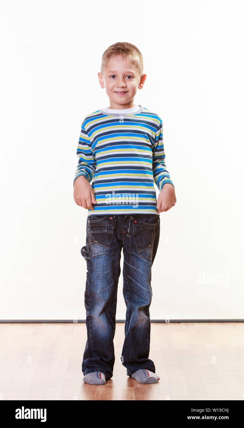 Free time, fun and expression. Little boy play alone indoors make silly ...