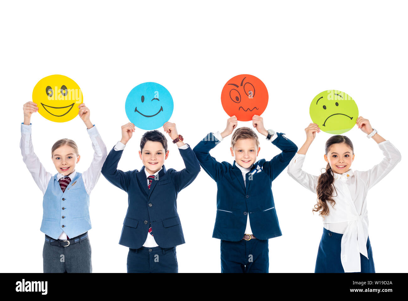 happy schoolchildren in formal wear holding cards with various face ...
