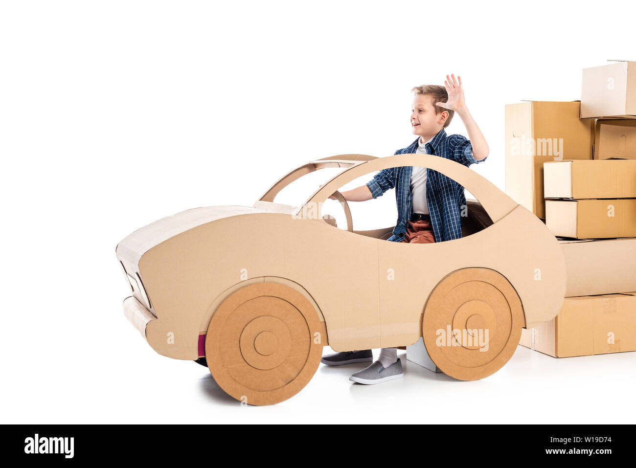 boy sitting in cardboard car and waving on white Stock Photo - Alamy