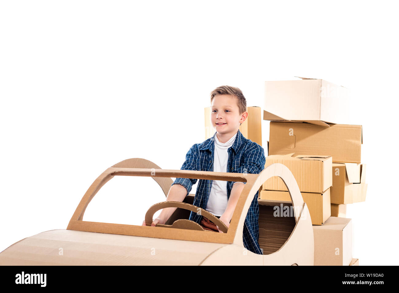 adorable boy playing with cardboard car Isolated On White with copy ...