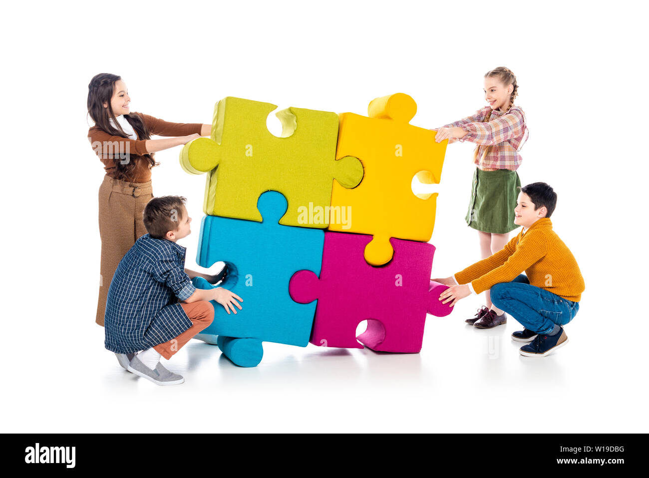 happy kids playing with jigsaw puzzle pieces on white Stock Photo - Alamy