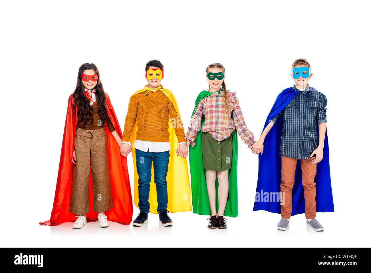 happy kids in superhero costumes and masks holding hands On White Stock ...