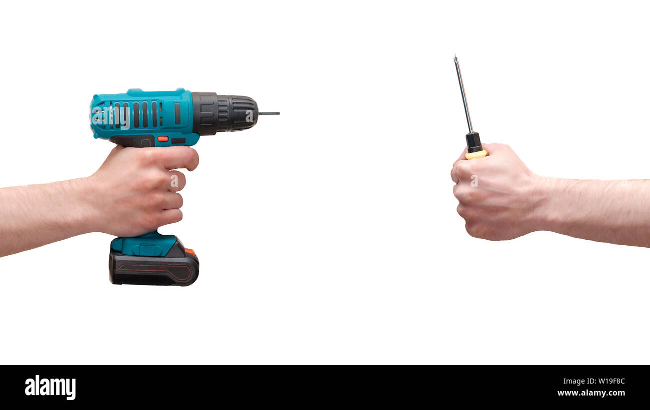 Male hands with a cordless screwdriver and cruciform hand screwdriver ...