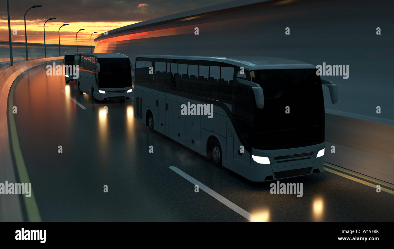 A convoy of three white buses drive on a highway at sunset backlit by a ...