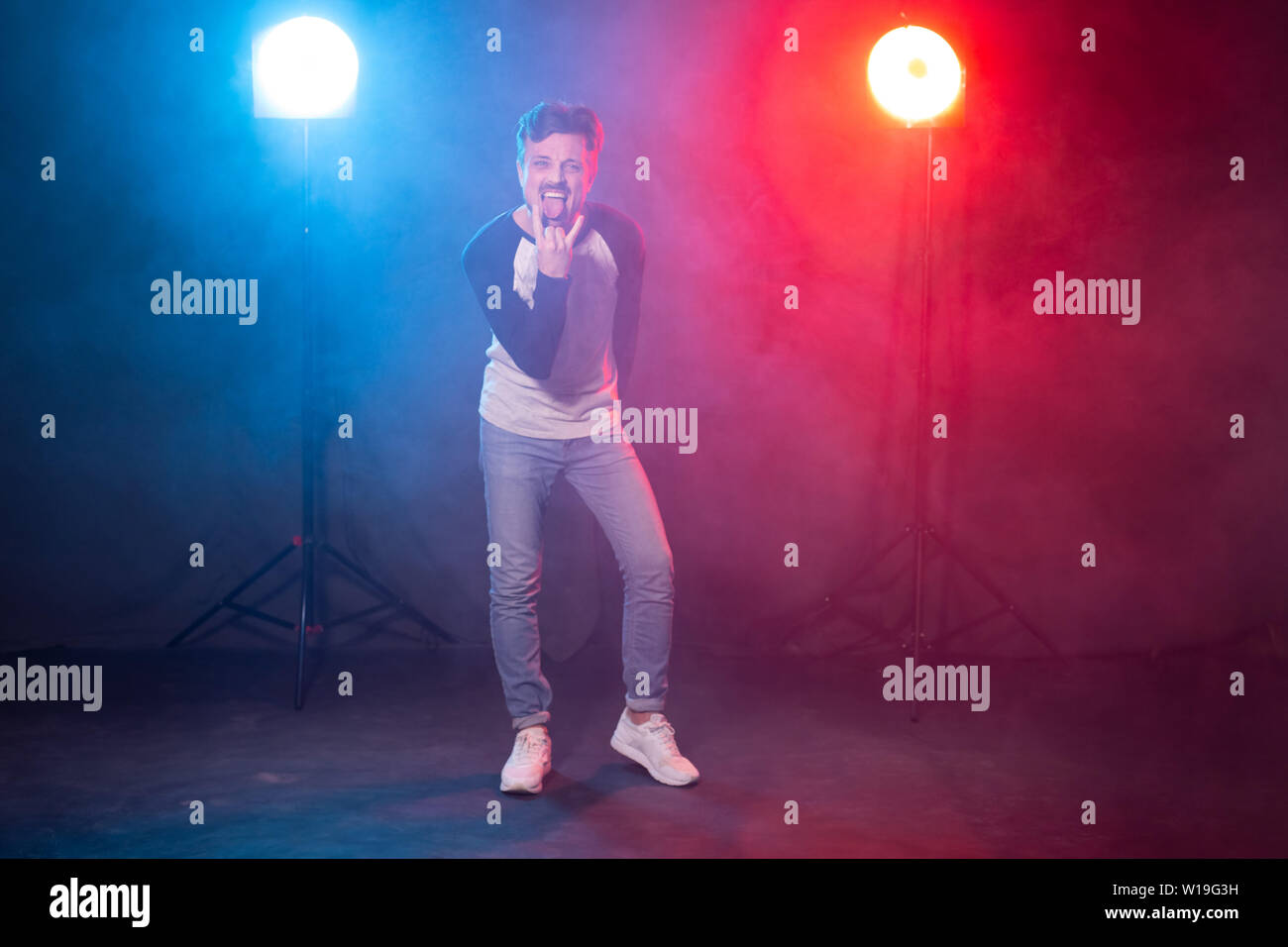 Jazz funk, dancing and hobby concept - young man dancing in spotlight ...