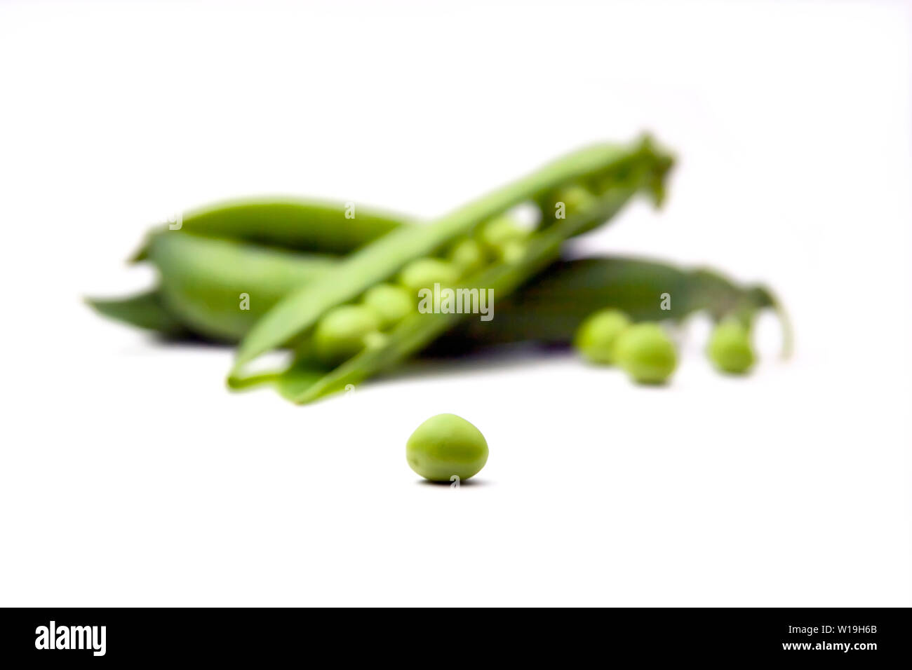 Fresh green peas isolated on white Stock Photo - Alamy
