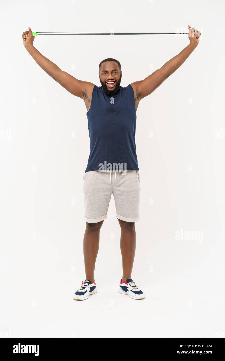 Shot of masculine man skipping rope. Muscular young man exercising with ...