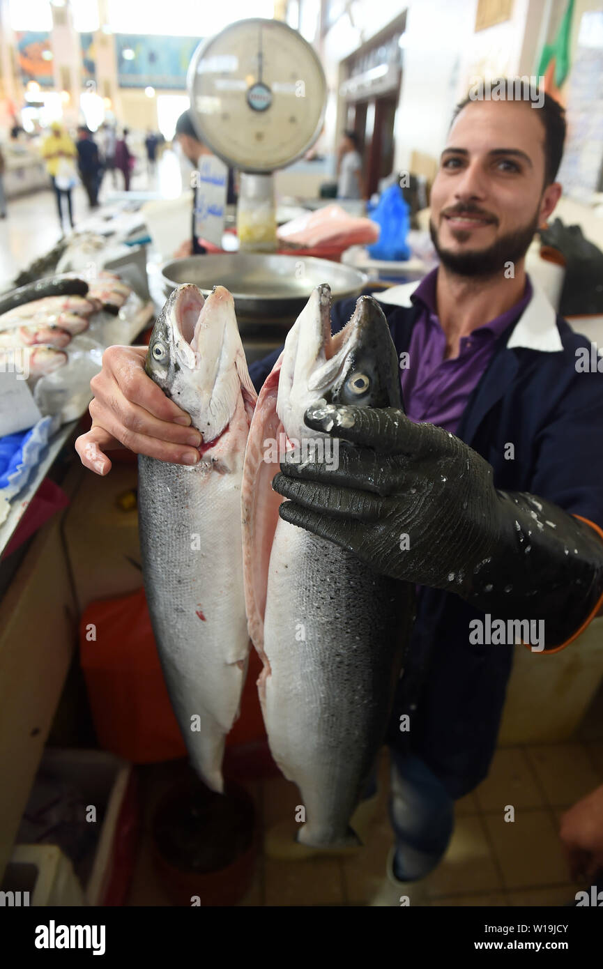 Kuwait City, Kuwait. 1st July, 2019. A fish vendor shows fishes at a ...