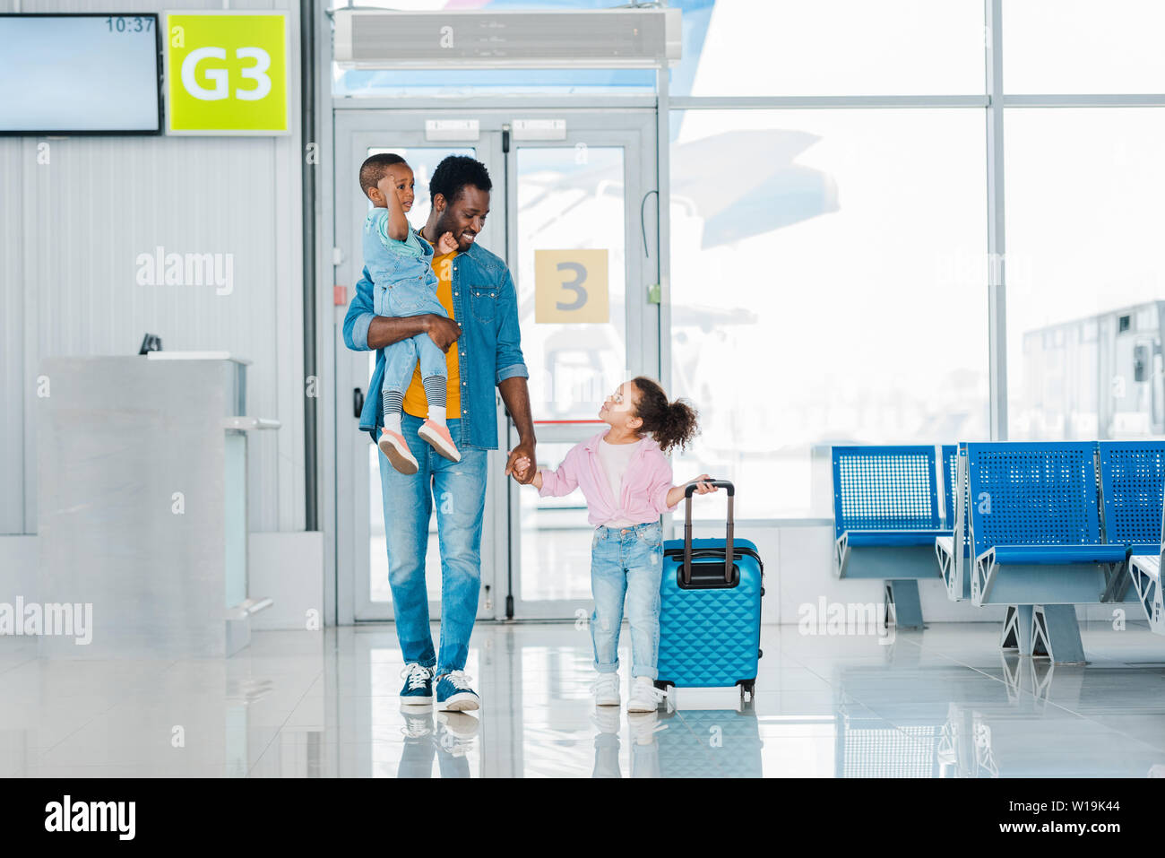 smiling happy african american father walking with children along ...