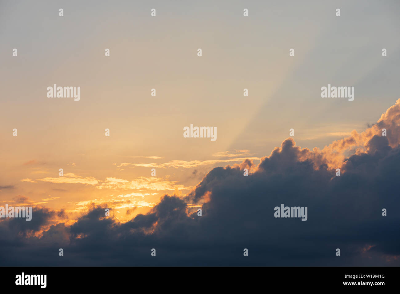 Sunset behind clouds after rain Stock Photo - Alamy