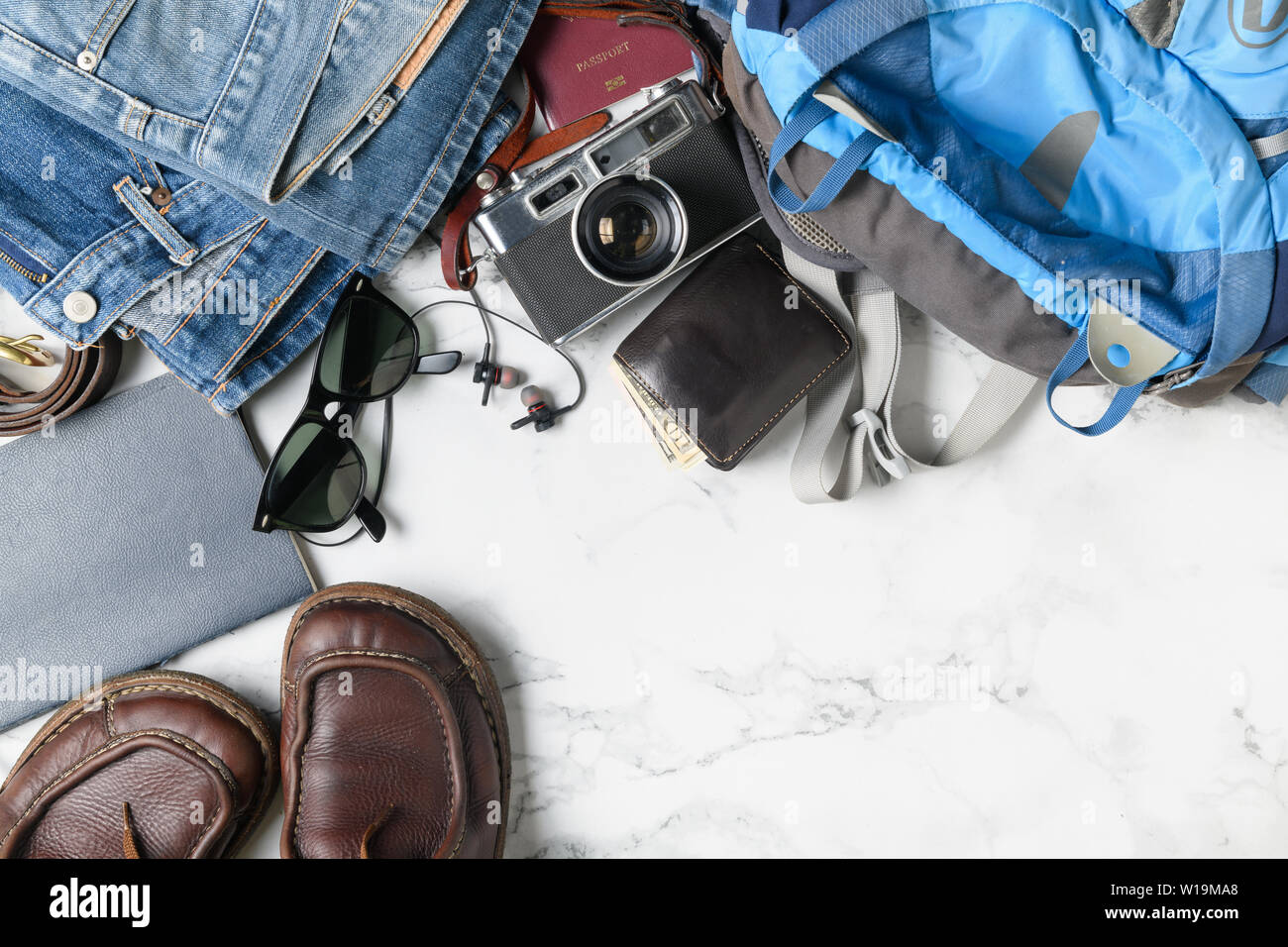 prepare backpack accessories and travel items on marble background with ...