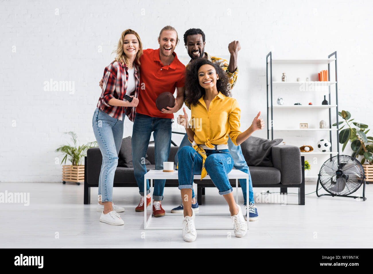 Four excited multicultural friends celebrating victory and spending ...