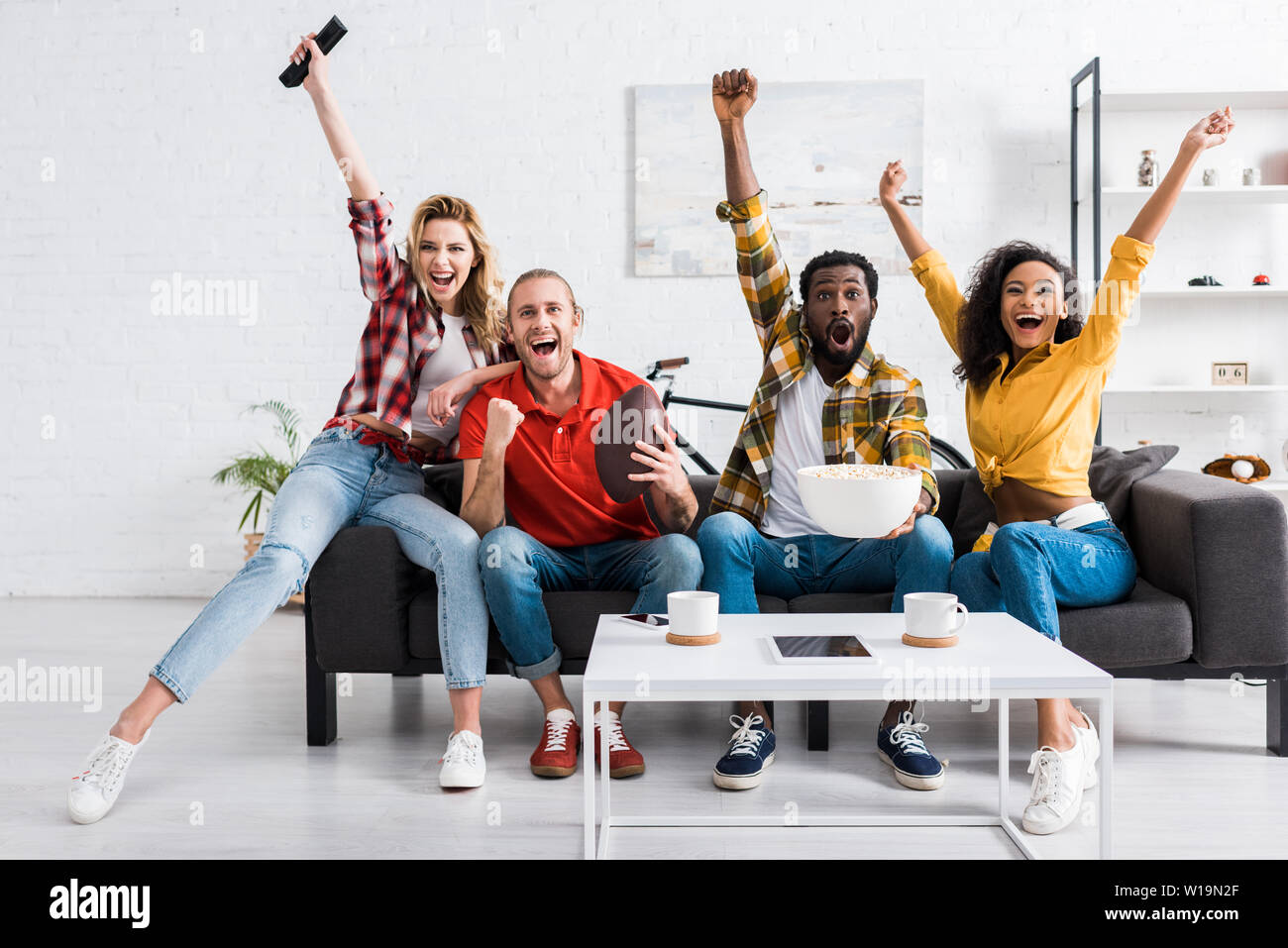 Happy multicultural friends watching sport match and having fun ...