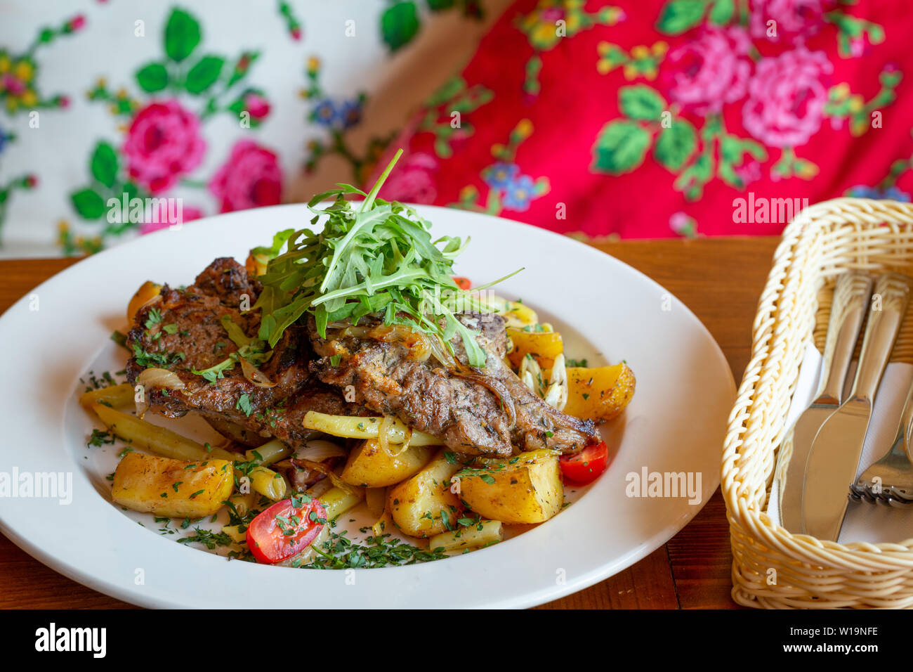 Roasted sheep meat with potatoes and beans Stock Photo - Alamy