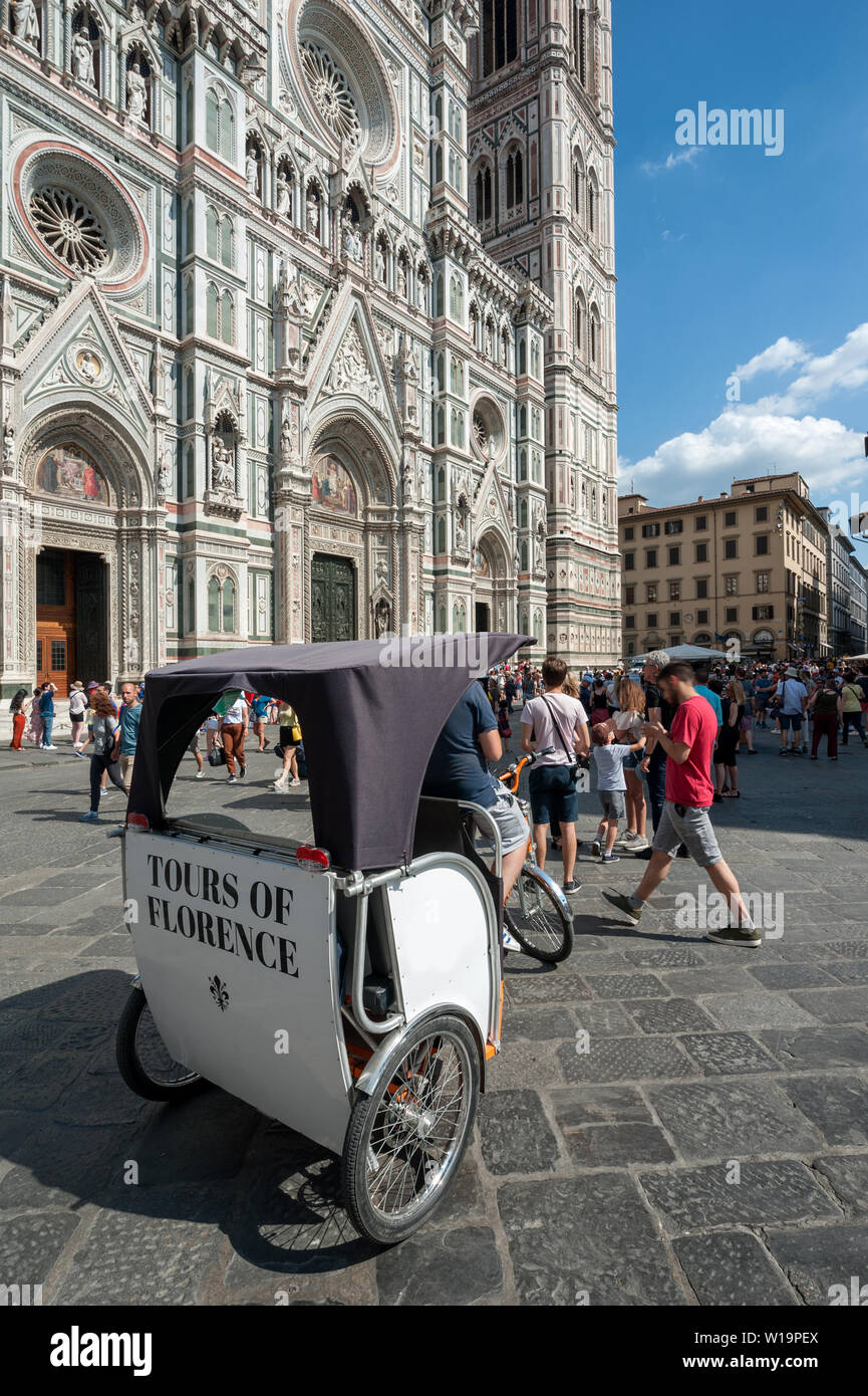 A rickshaw in Santa Maria del Fiore Cathedral, in Florence. Tourists ...