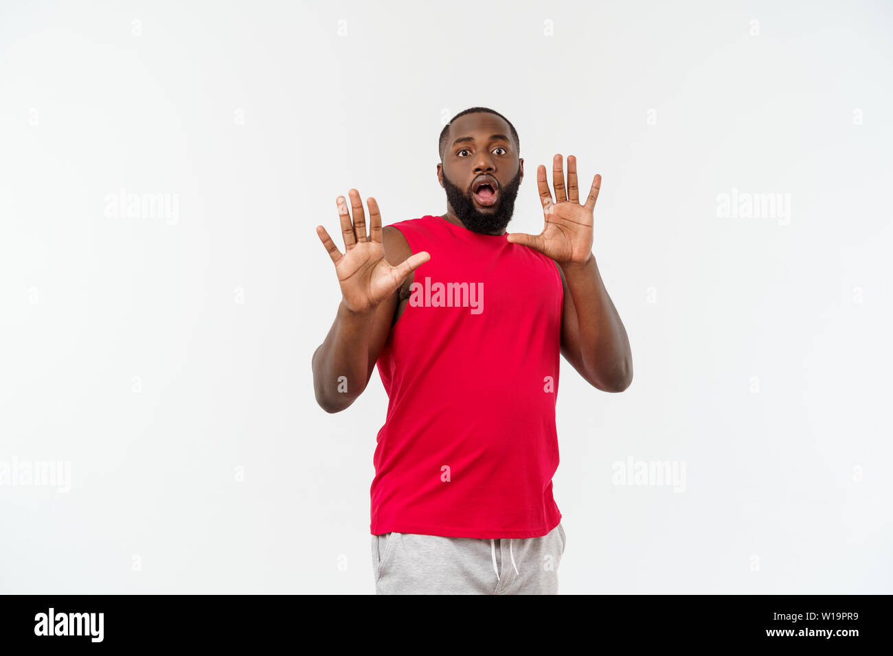 Young sport black man over an grey background very scared and afraid ...