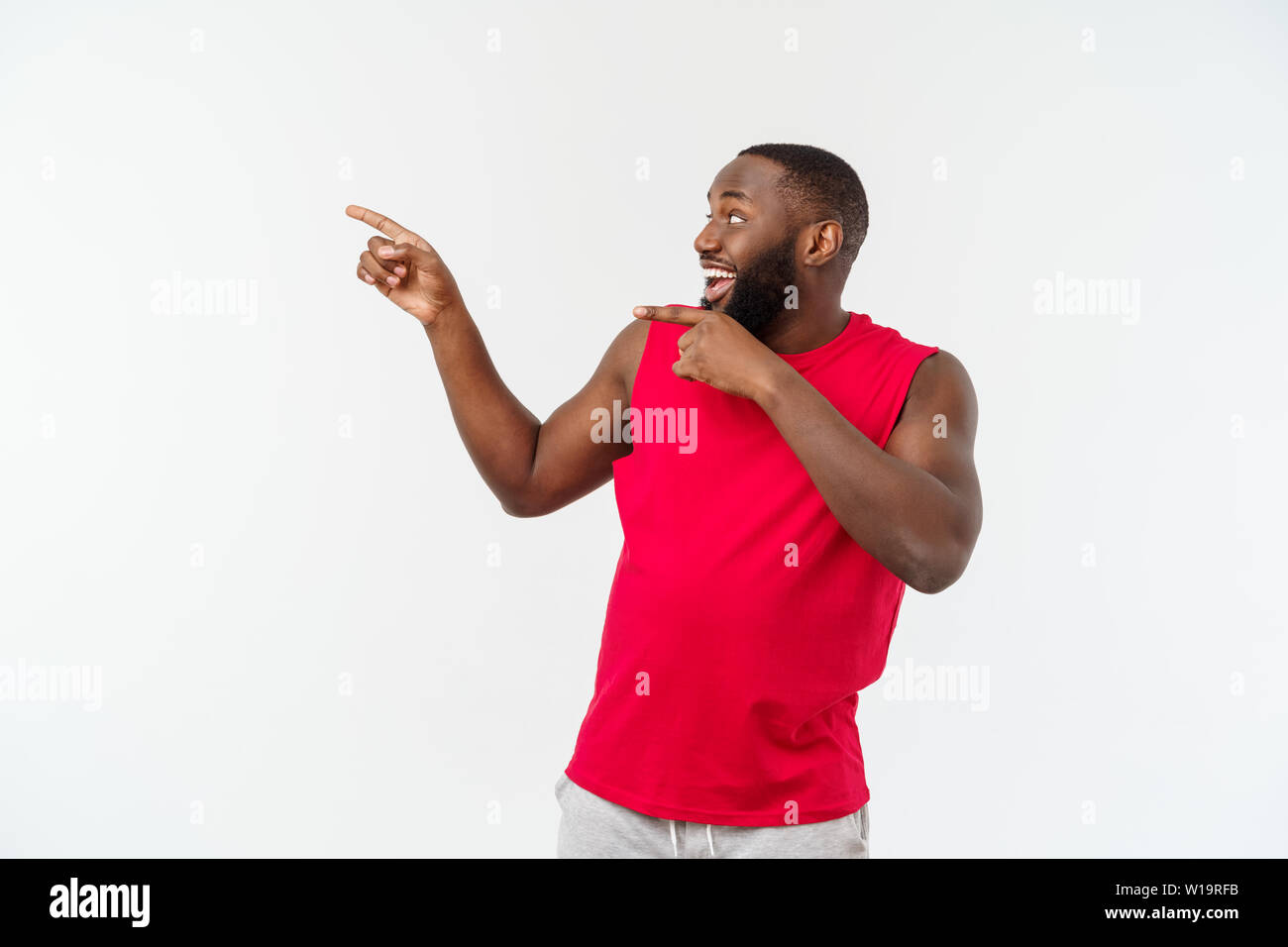 Young african american sport man pointing finger with surprised, feels ...