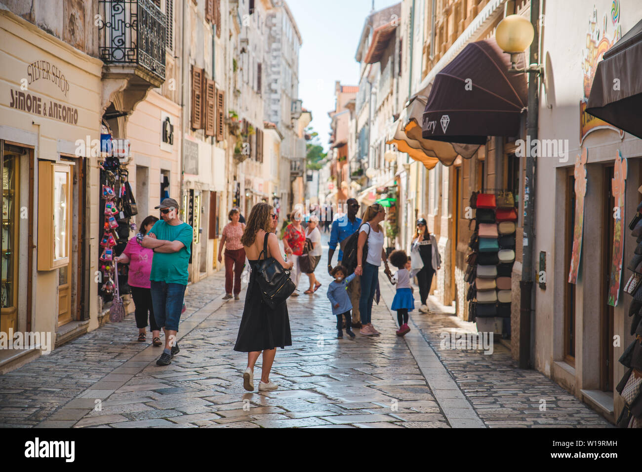 POREC, CROATIA - 19 May, 2019: woman walking by small porec streets in ...