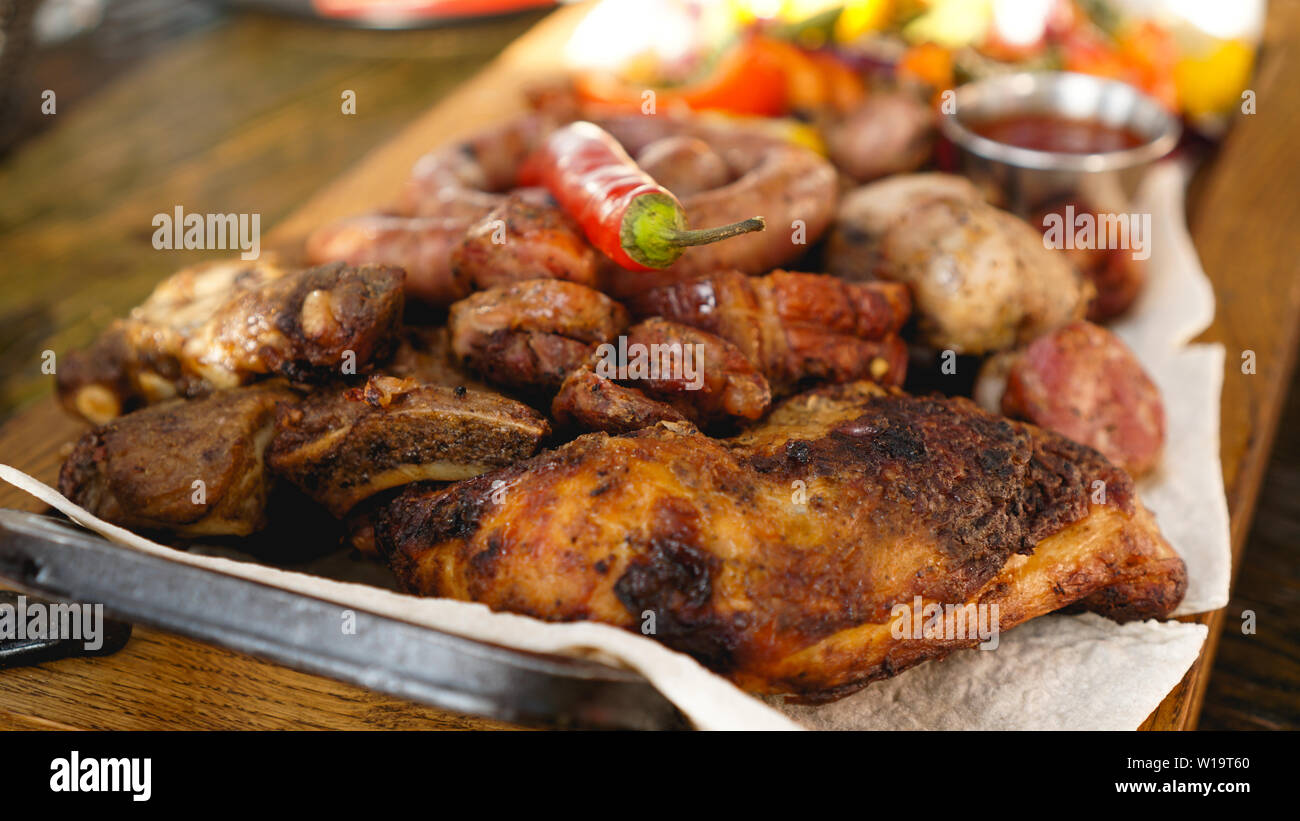 Mixed grilled meat platter. Assorted delicious grilled meat with vegetable. Mixed grilled meat ...