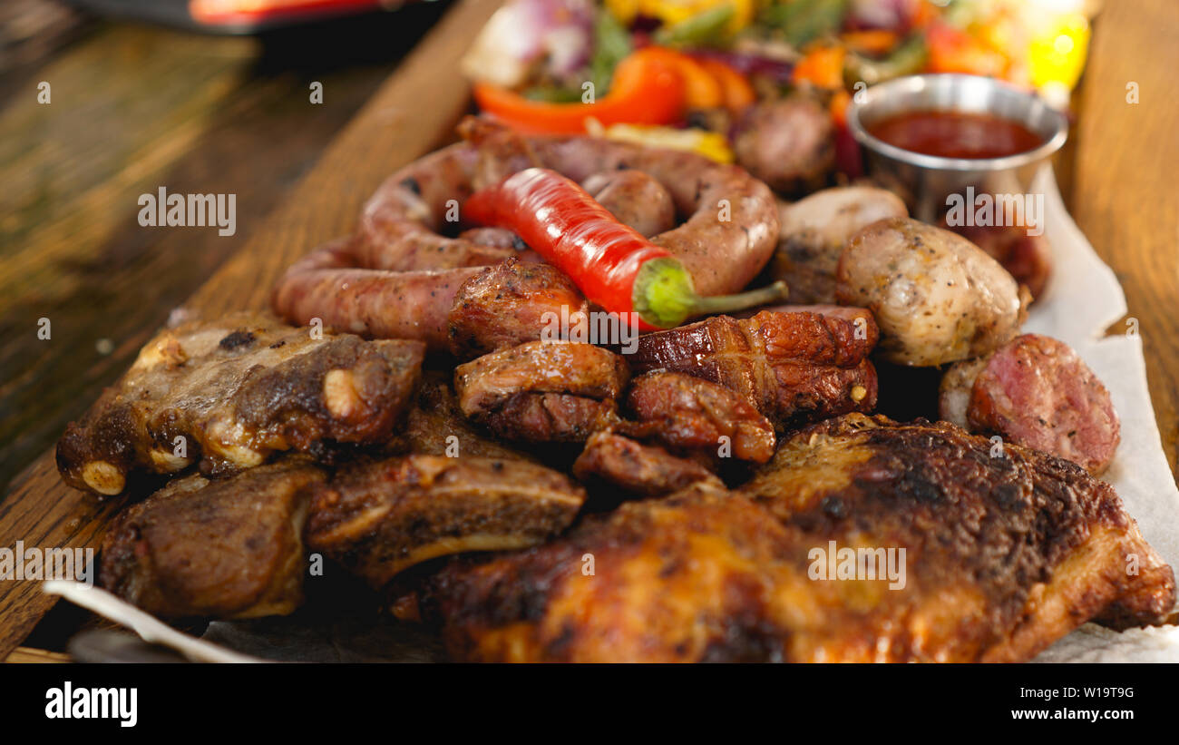 Mixed grilled meat platter. Assorted delicious grilled meat with ...