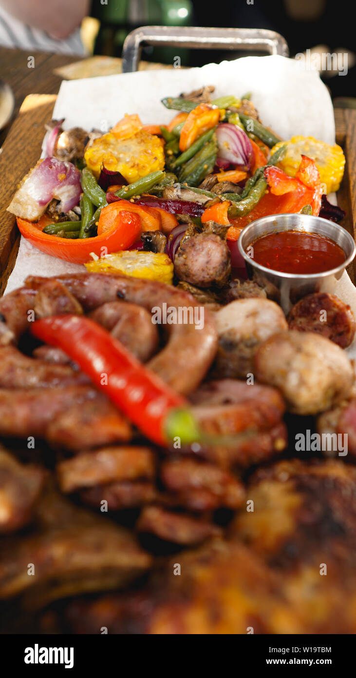 Mixed grilled meat platter. Assorted delicious grilled meat with vegetable. Mixed grilled meat ...
