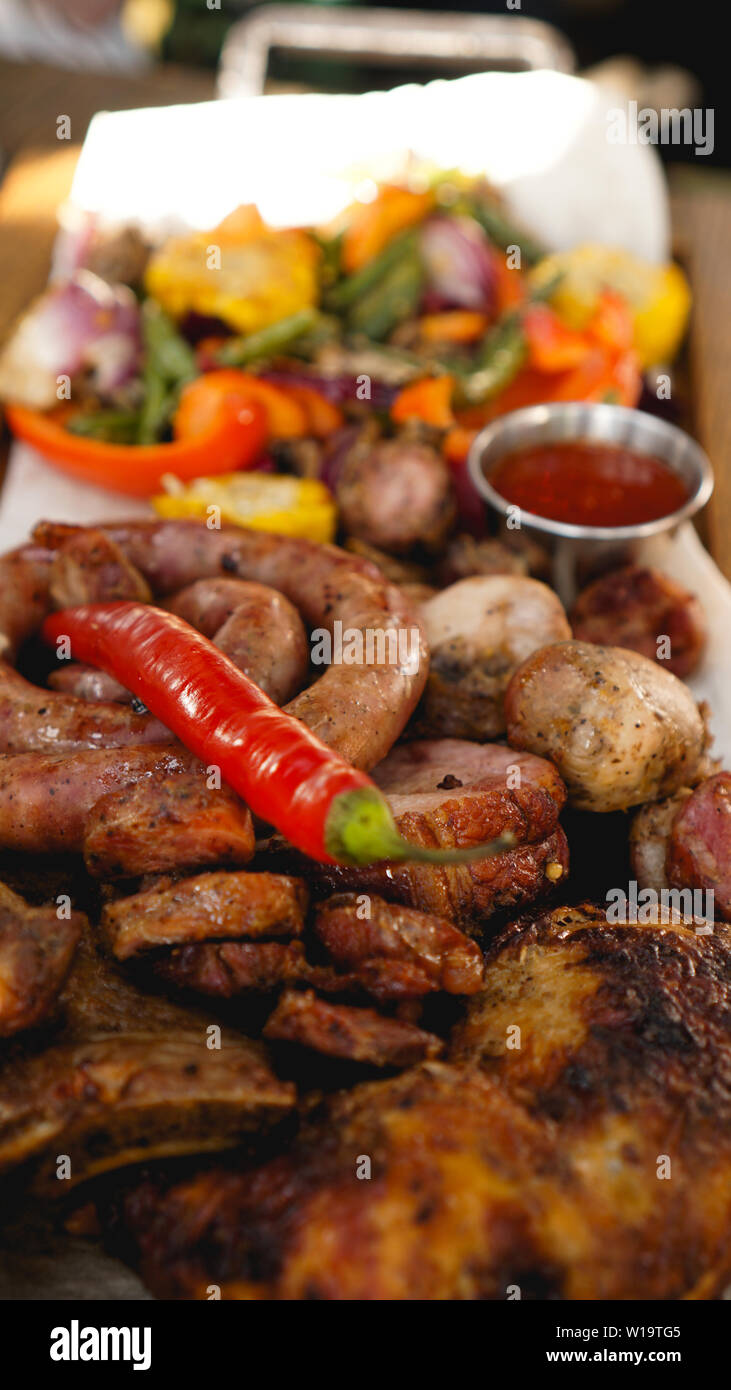 Mixed grilled meat platter. Assorted delicious grilled meat with ...