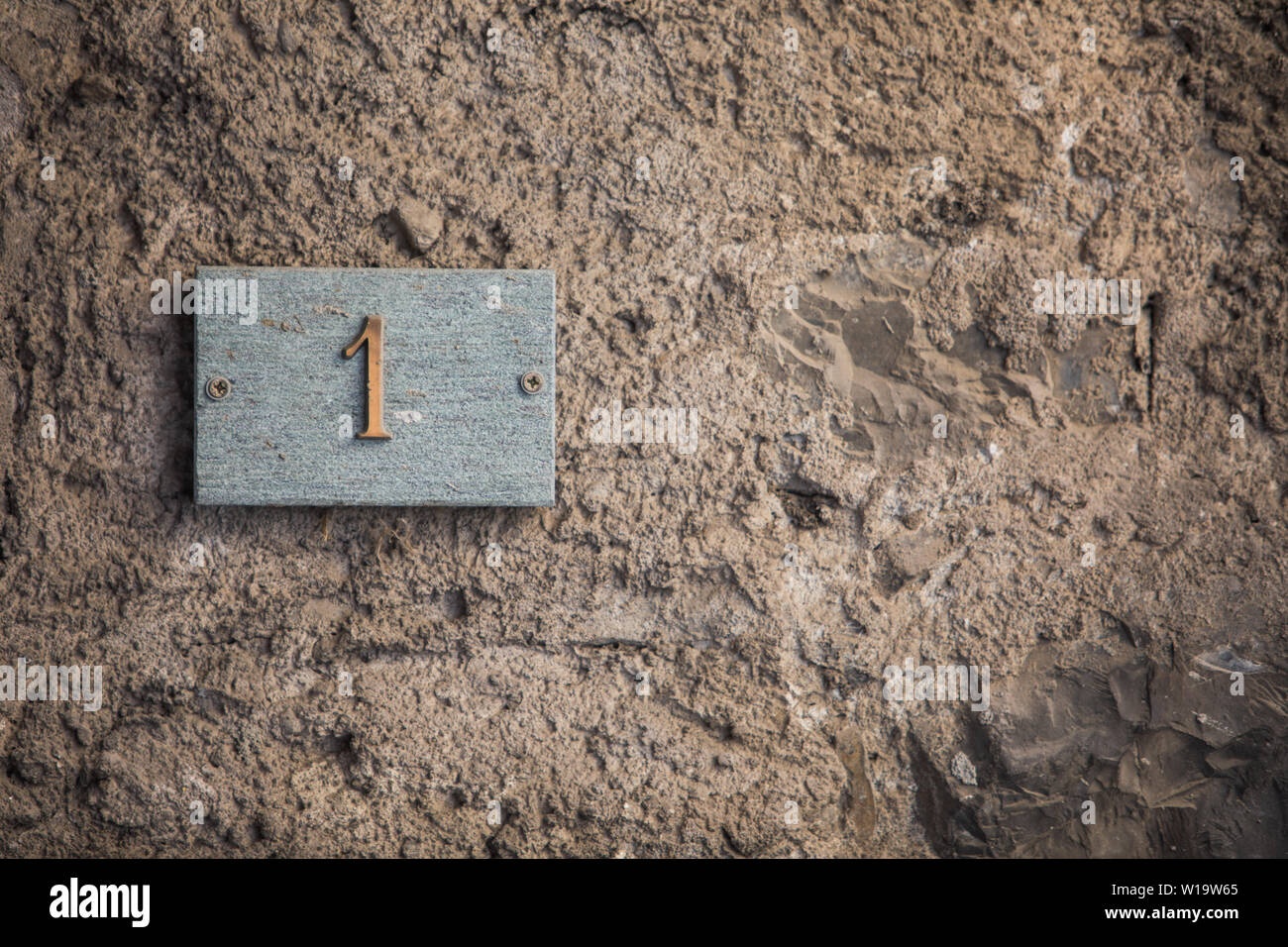 House number with number one, on a wall Stock Photo - Alamy