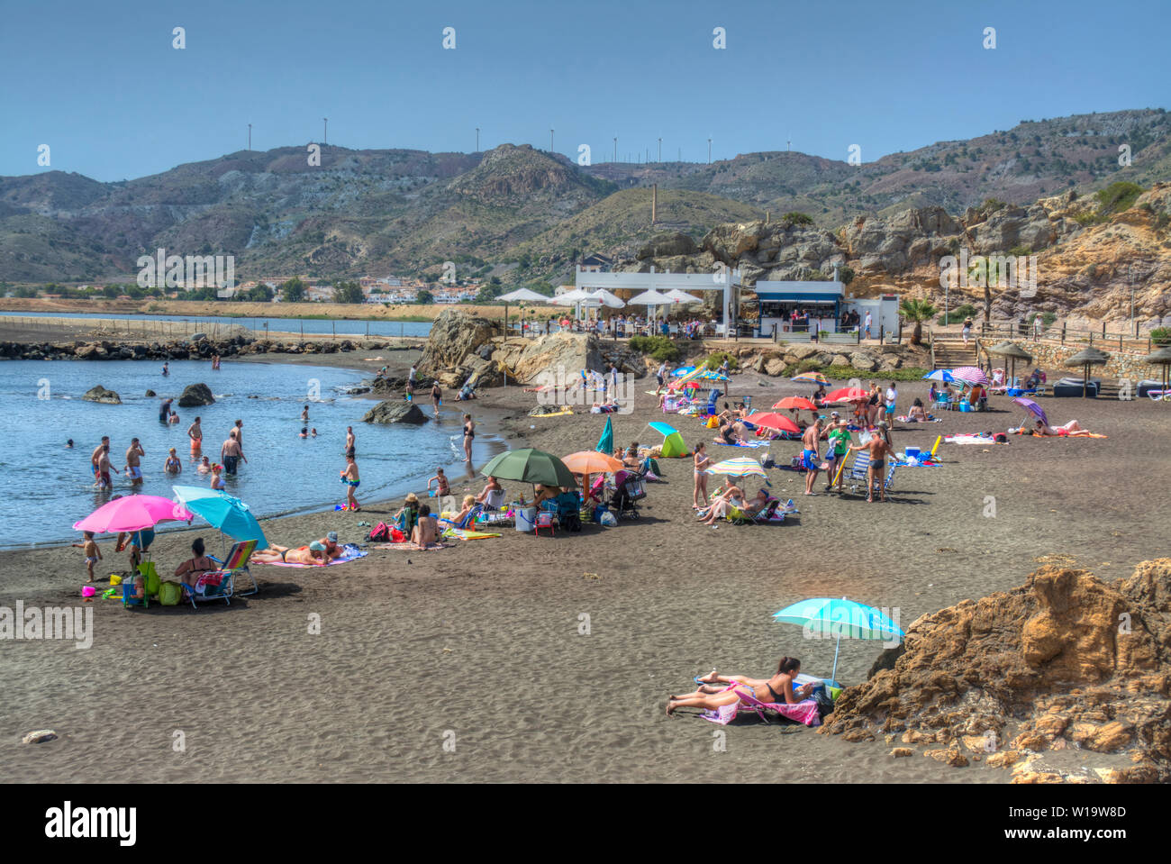 HDR image of the sunbathers on the Black sand beach at Portman in ...