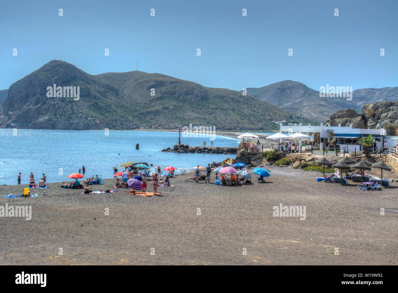 HDR image of the Black sand beach and beach bar at Portman in Murcia ...
