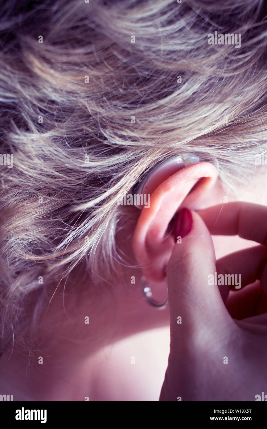 Deaf lady with modern technology digital hearing aid in her ear Stock ...