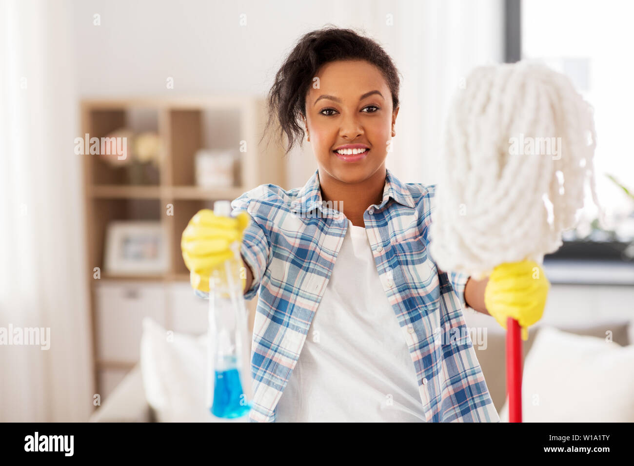 african american woman with mop cleaning at home Stock Photo - Alamy