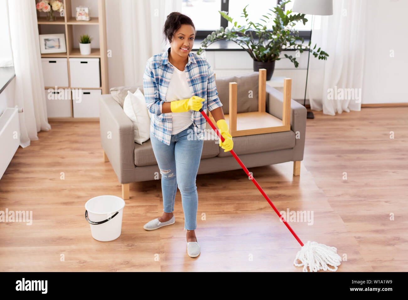 african woman or housewife cleaning floor at home Stock Photo - Alamy
