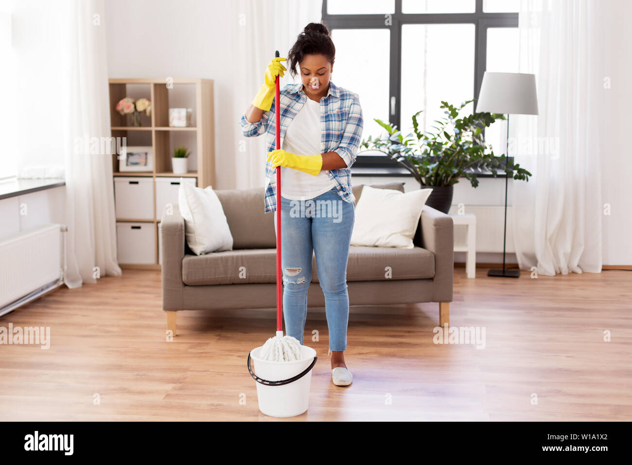 african woman or housewife cleaning floor at home Stock Photo - Alamy