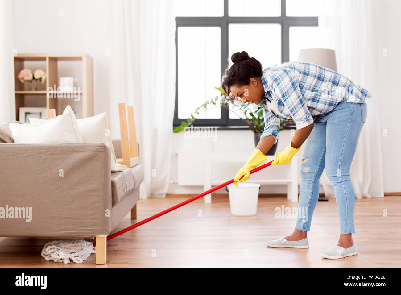 african woman or housewife cleaning floor at home Stock Photo - Alamy
