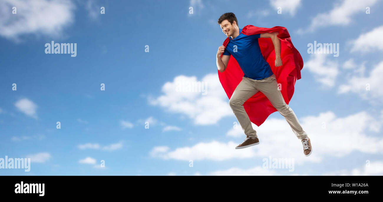 man in red superhero cape flying over sky Stock Photo - Alamy