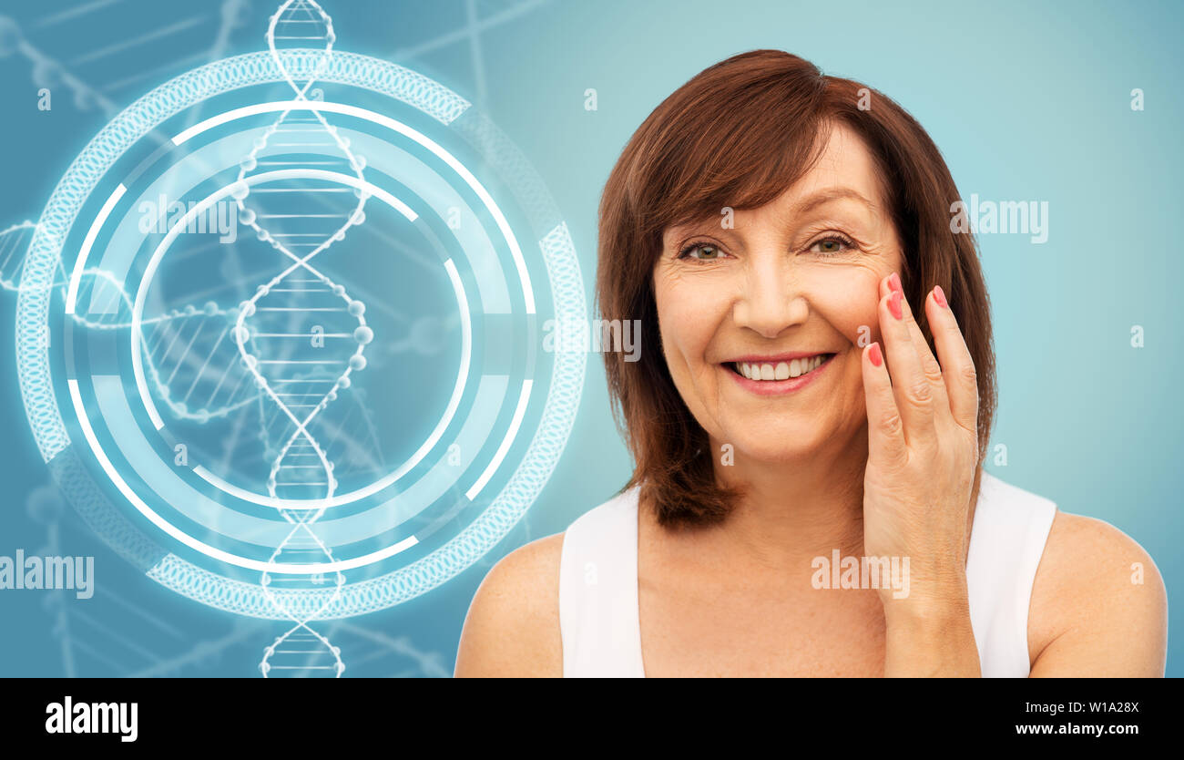 senior woman touching her face over dna molecule Stock Photo - Alamy