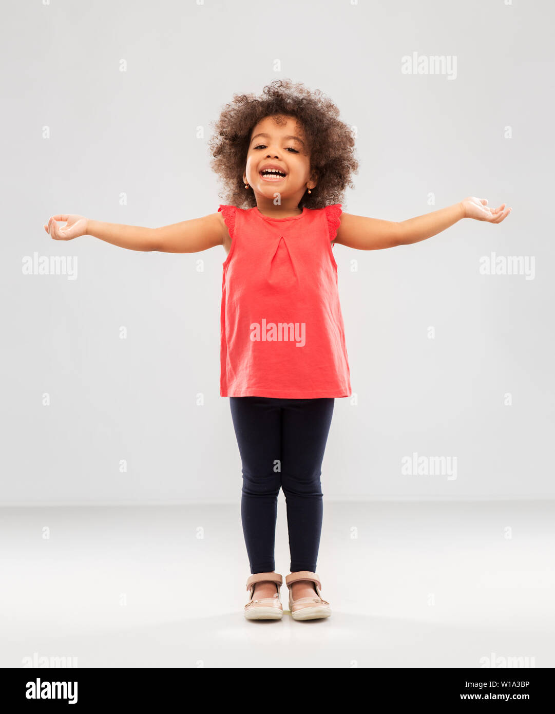 happy little african american girl with arms apart Stock Photo - Alamy