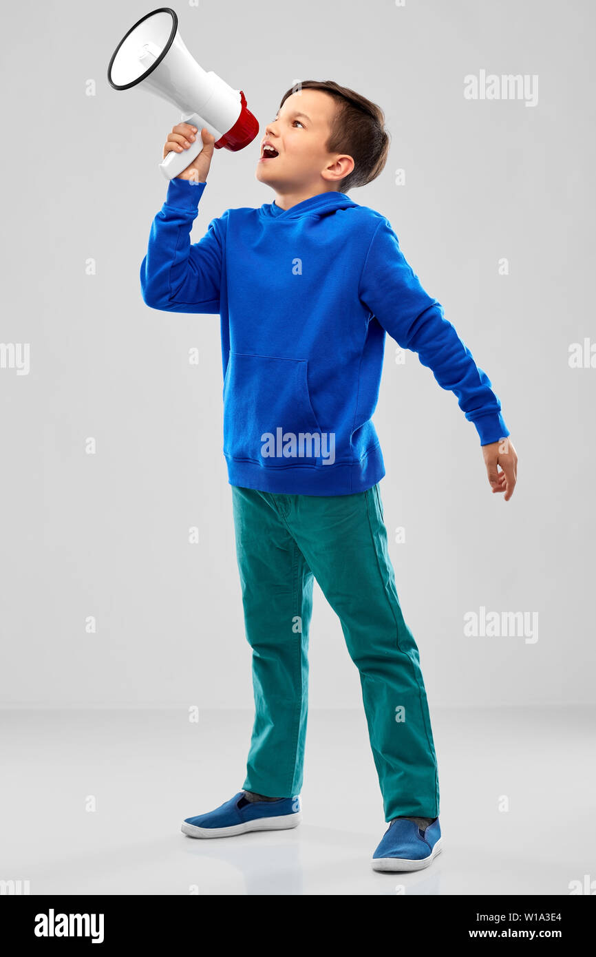 smiling boy speaking to megaphone Stock Photo - Alamy