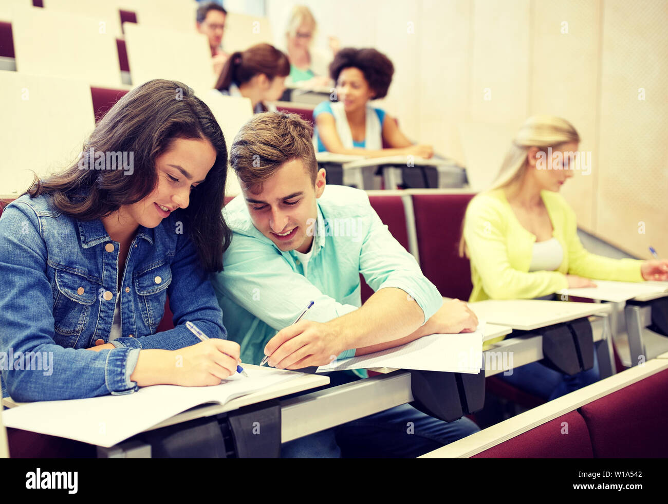 group of students with notebooks at lecture hall Stock Photo - Alamy