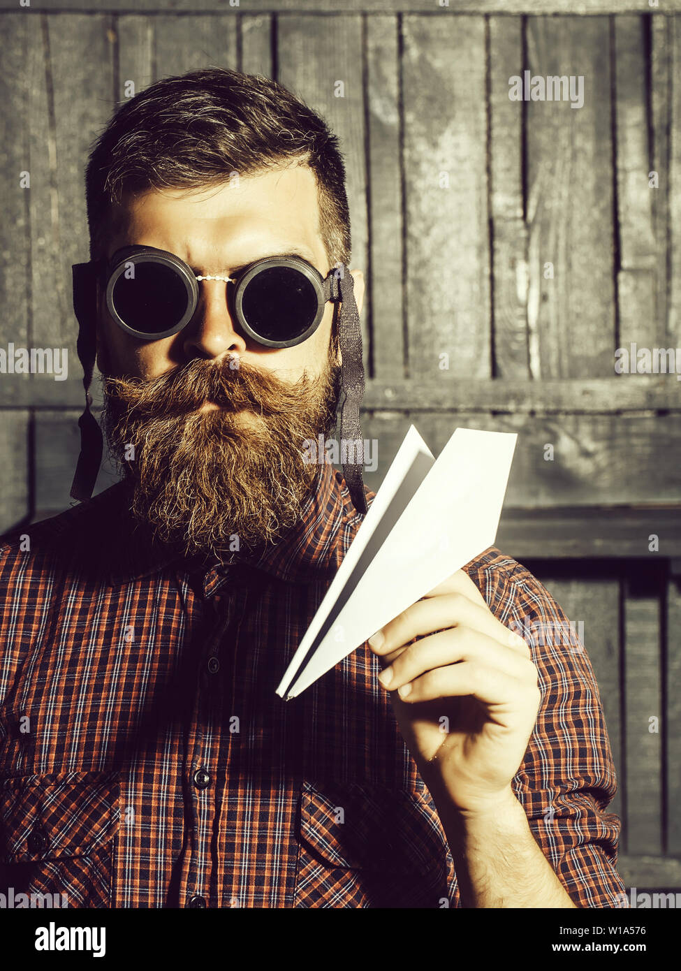 Bearded man with paper plane Stock Photo - Alamy