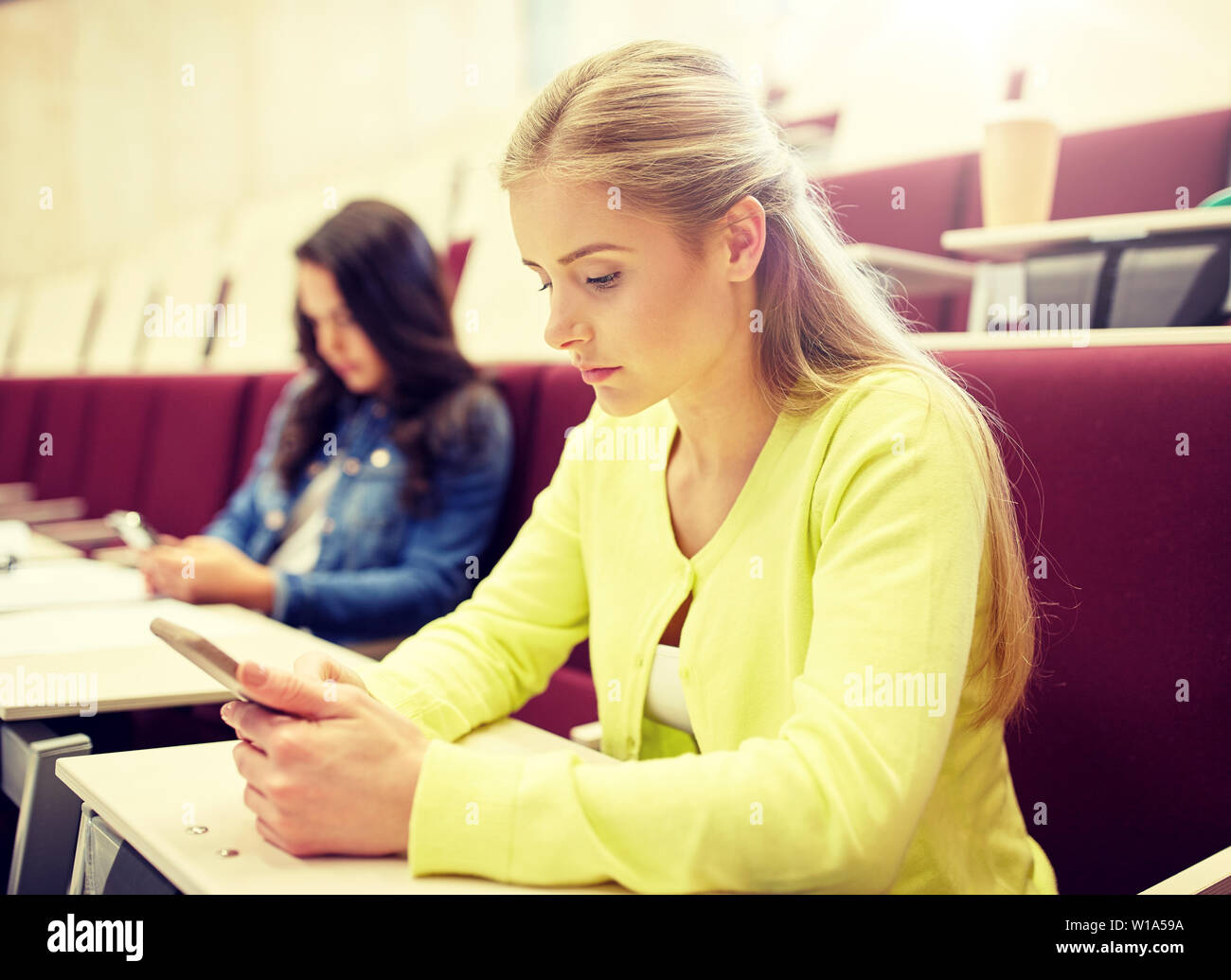 student girls with smartphones on lecture Stock Photo - Alamy