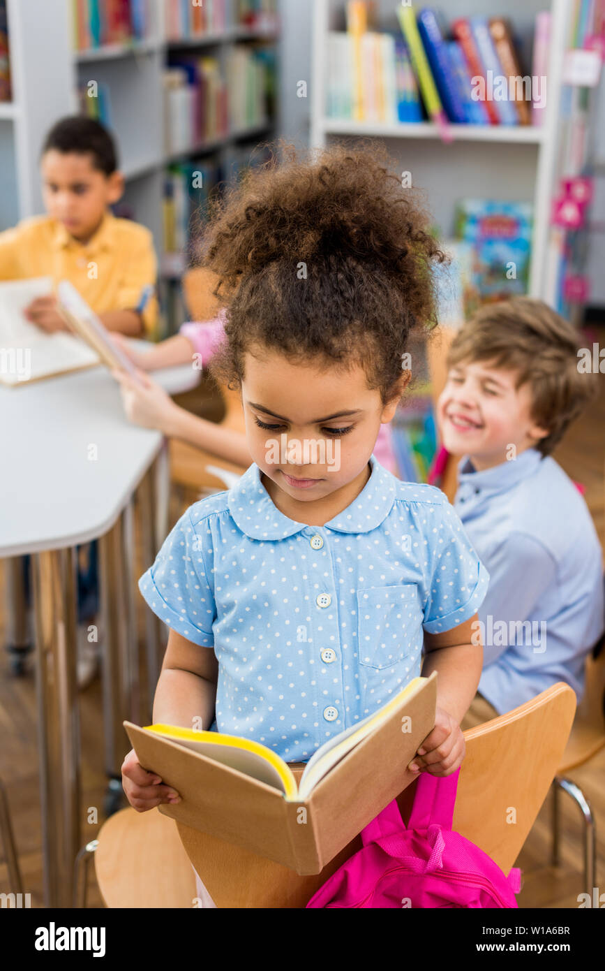 selective focus of african american kid reading book in library Stock ...
