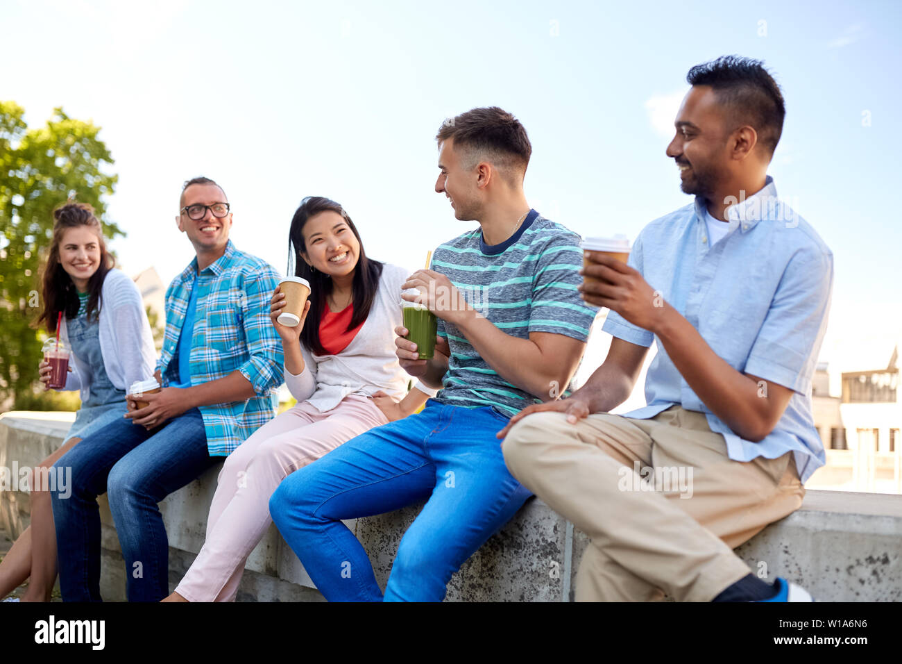 Friends drinking coffee juice talking hi-res stock photography and ...