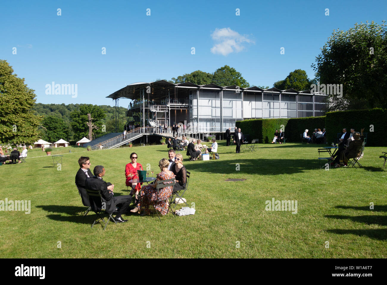 Garsington Opera UK; people sitting outside drinking champagne and ...