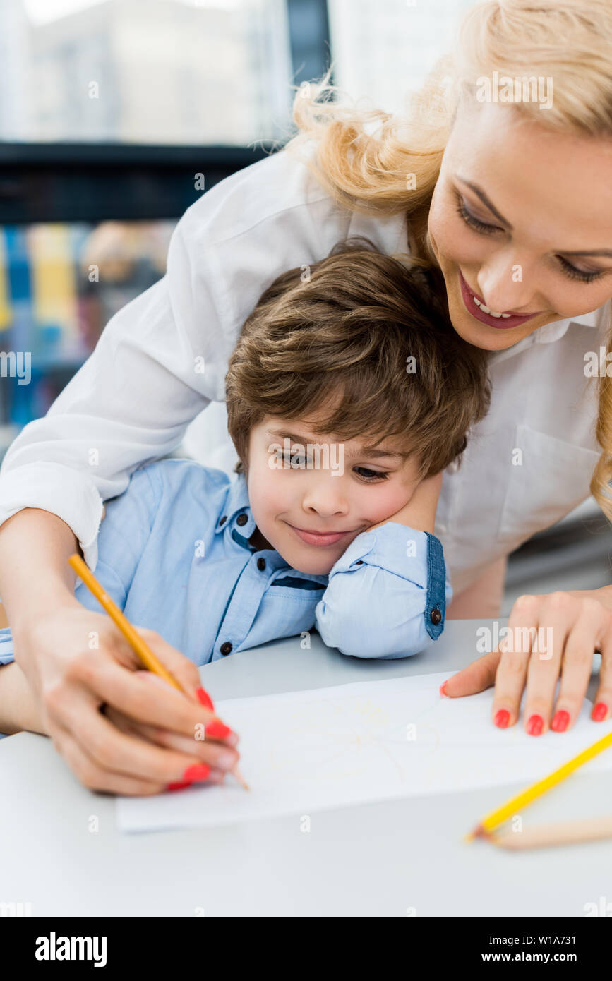 selective focus of happy woman drawing with cute kid Stock Photo - Alamy