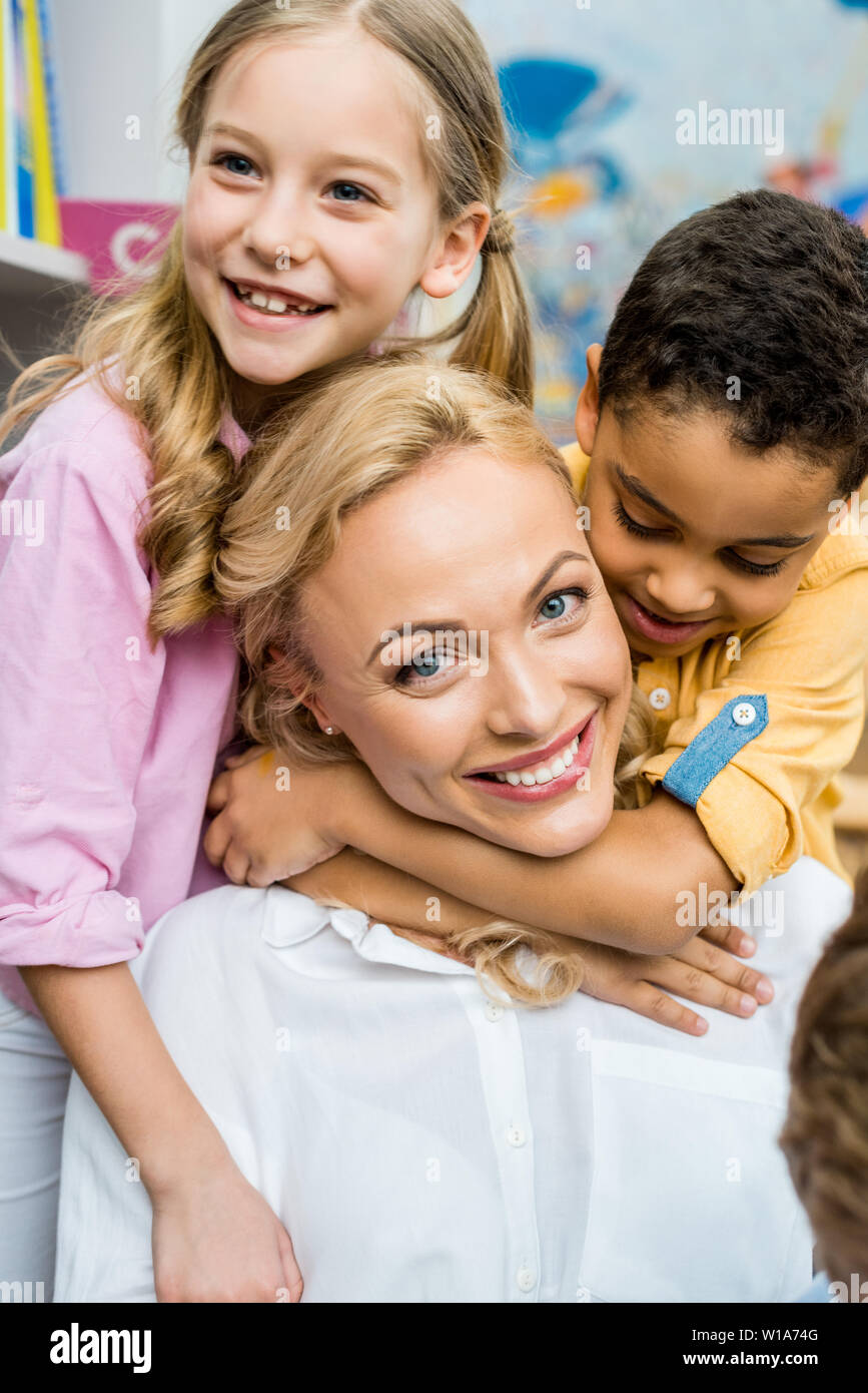 cute kids hugging happy woman standing near adorable boy Stock Photo ...