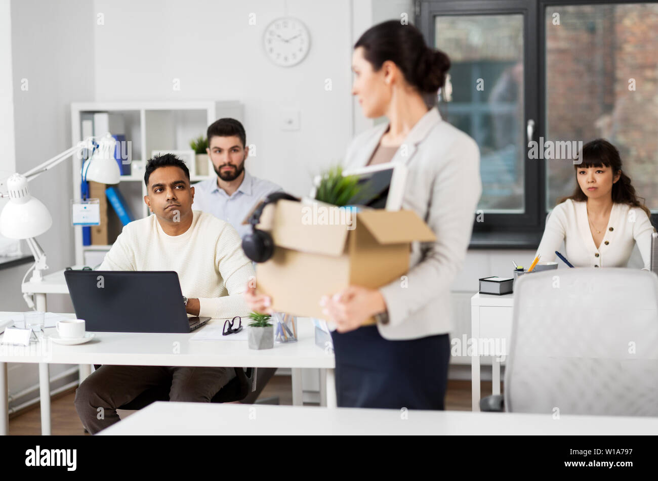 female office worker with box of personal stuff Stock Photo - Alamy