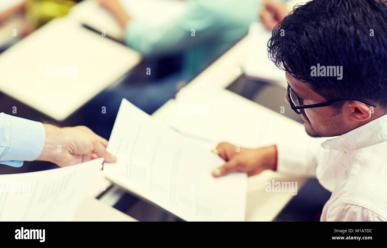 teacher giving exam test to student at lecture Stock Photo - Alamy